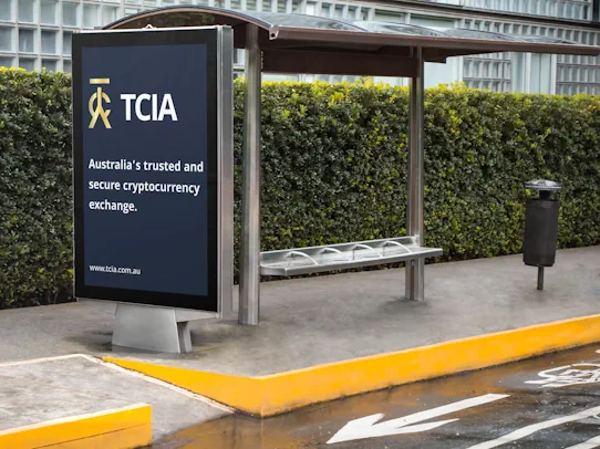 A picture of a bus stop with a TCIA ad